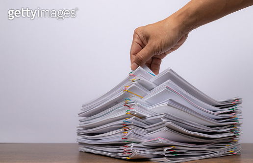 man hand pick up Stack overload document report paper, concept of ...