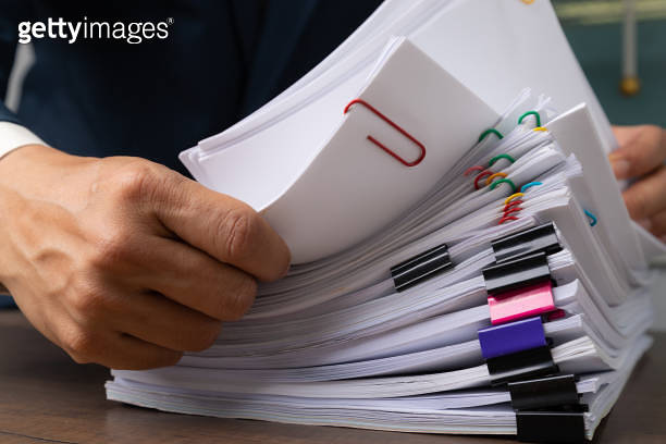 Business man hand pick up Stack overload document report paper with ...