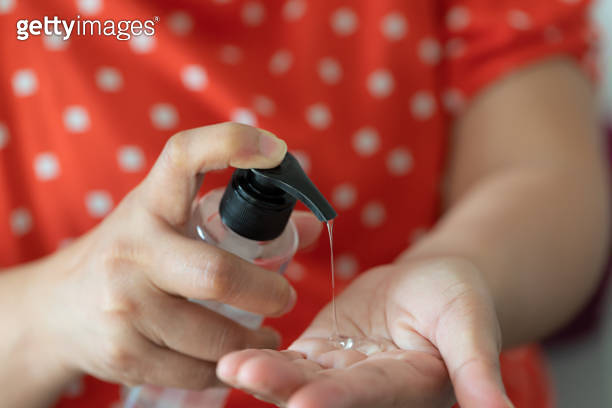 Close-up woman washing hands with alcohol gel to prevent infection ...