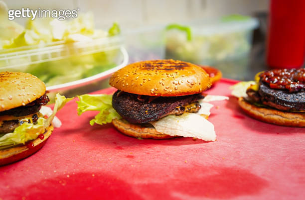 Rare burger with black puddling meat cooked in fast food restaurant for ...