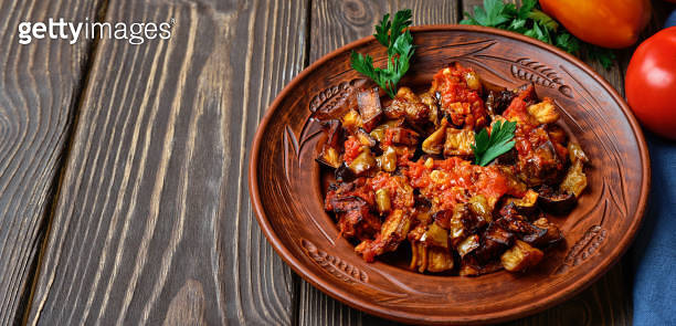 Grilled Turkish eggplants in tomato sauce (soslu patlican or akuka.). A ...