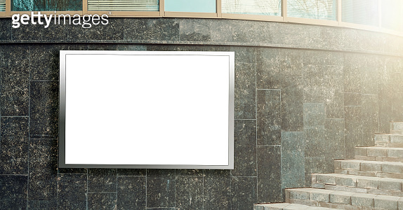 blank mock-up panel with space for design with metal frame on grey wall ...