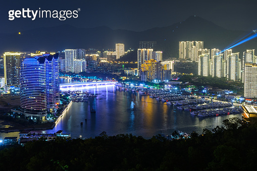 Night view of Sanya city with bright multi-colored illumination ...