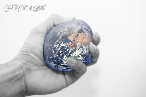 Hand squeezing the world. World crisis, saving earth concept. Element ...