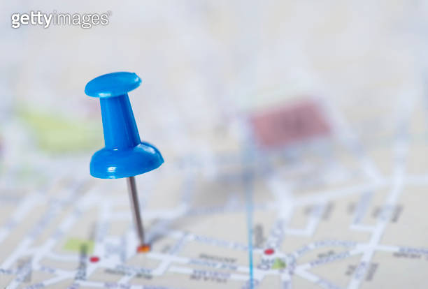 Blue push pin stuck in a street map 이미지 (1202674502) - 게티이미지뱅크