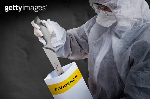 Forensic technician collecting evidence at crime scene,forensic science ...