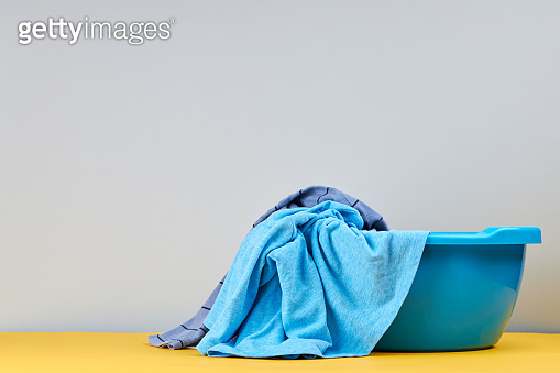 stack of a colored clothes for laundry cleaning and washing service ...