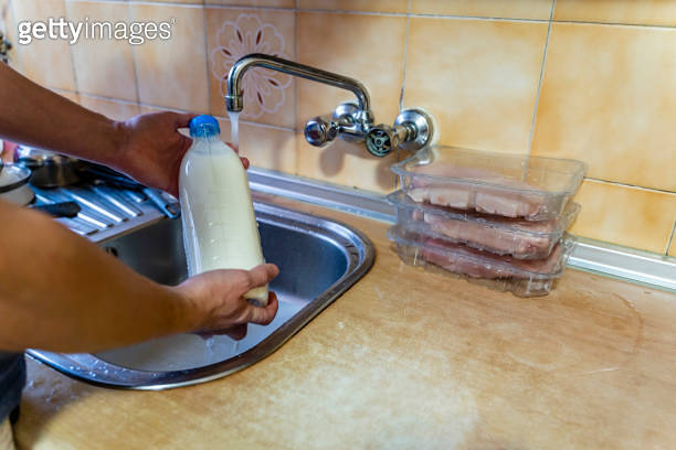 Washing groceries, plastic milk bottle, disinfecting after shopping in ...