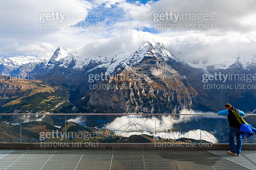 A tourist at the viewpoint deck located at Birg cableway station ...