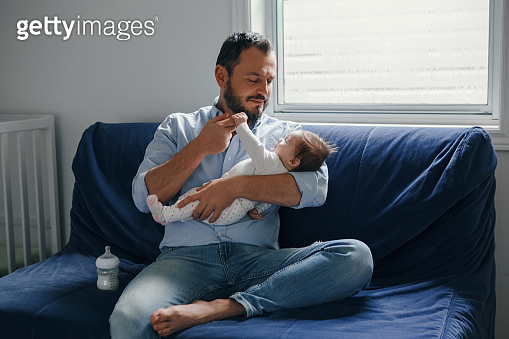 Proud Caucasian father with newborn baby girl. Parent holding rocking ...