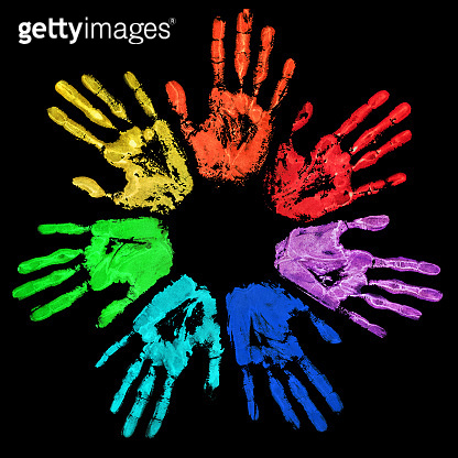 Rainbow color hands print in circle on black background isolated close ...