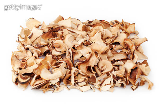 Edible dried mushrooms pile on white background close up, dry boletus ...