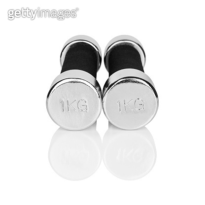 Two 1 kg dumbbells white background & reflection isolated close up ...