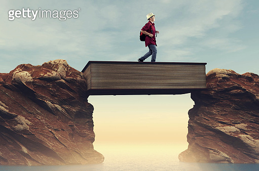 Student running over a gap between mountains on a book . Overcome any ...