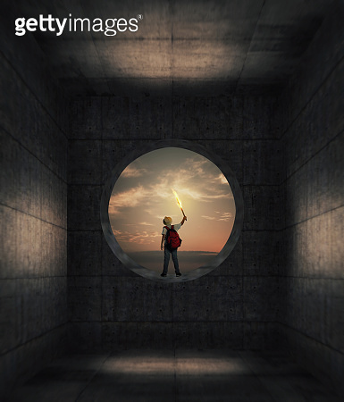 Traveler looking through round concrete window to the sky . Isolated in ...