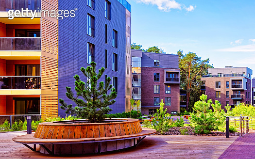 Pine trees at Modern architectural complex of apartment residential ...