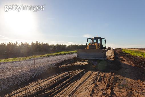 Bulldozer during road construction. Construction machinery. Earth ...