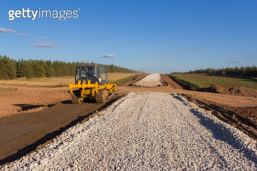 Bulldozer during road construction. Construction machinery. Earth ...
