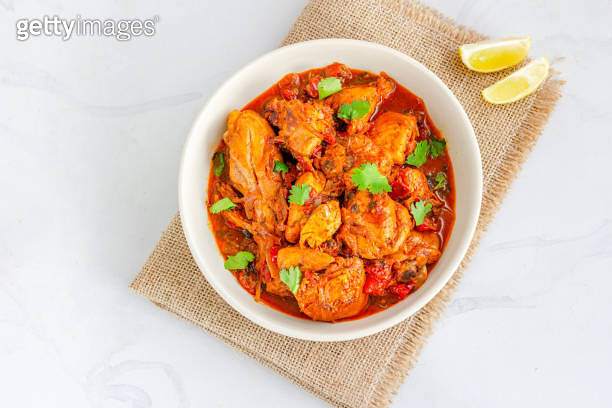 Spicy Indian Style Chicken Curry Garnished with Cilantro and Lemon ...