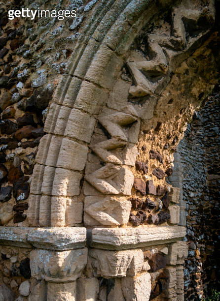 Detail from a Norman arch in the ruins of St James' church, Bawsey ...
