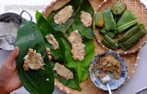 Woman hand making flat rice dumpling, stuffing from vegetable onto rice ...