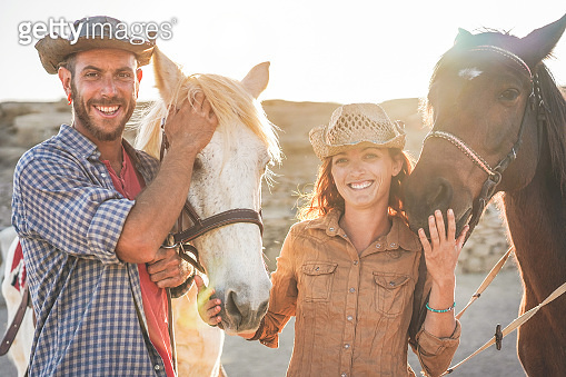 Animals lovers couple taking with bitless horses during sunny day ...