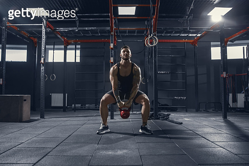 The male athlete training hard in the gym. Fitness and healthy life ...
