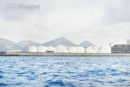 Oil terminal and cargo port, close-up view from the sailing boat ...