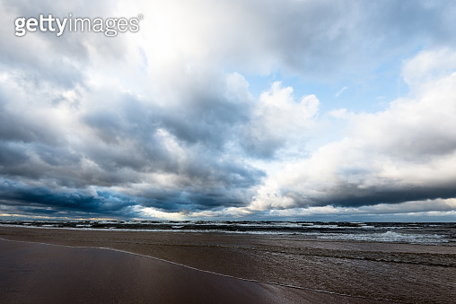 Storm clouds above the sea. Waves and water splashes. Warm evening ...