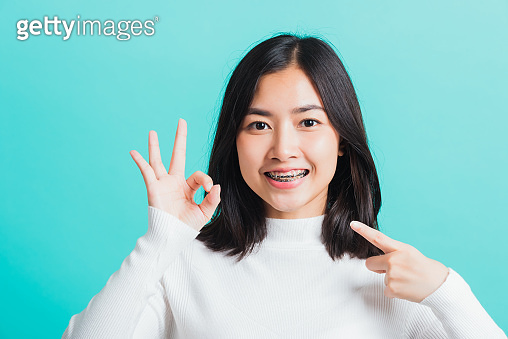 woman smile have dental braces on teeth laughing she showing gesturing ...