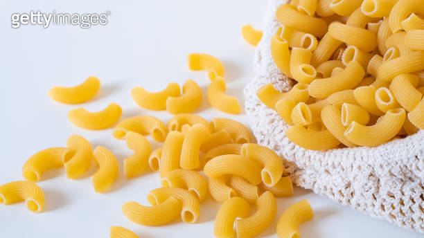 Raw dry uncooked Elbow Macaroni pasta spaghetti on white background ...