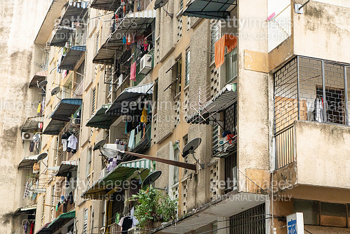 The balconies of an apartment building are hung with clothes. The poor ...
