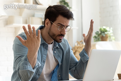 Angry frustrated young man furious about laptop computer malfunction ...