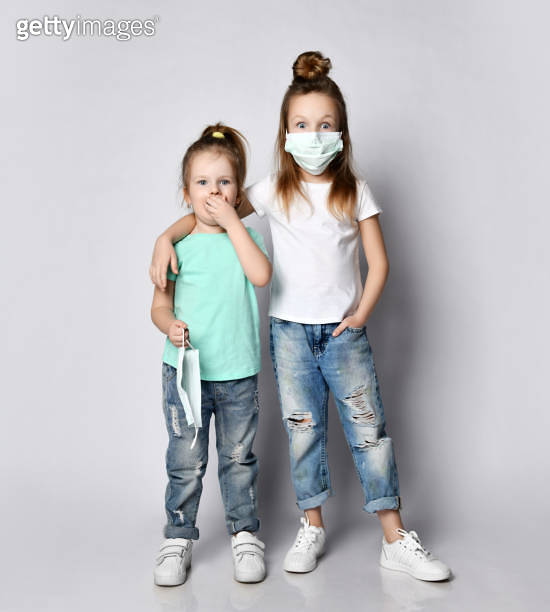 Two scared children girls kids in medical masks from the Coronavirus ...
