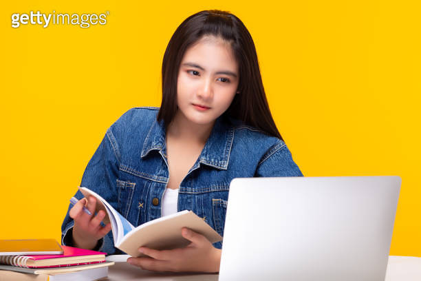 Young asian student watching lesson online and open book, she study at ...