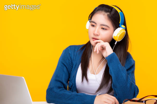 Young student watching lesson online and wear headphone, she study at ...