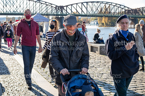 People with and without face masks at the Naplavka farmers market ...