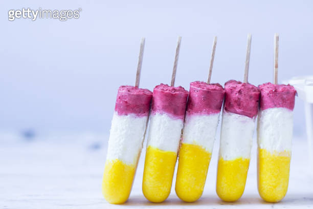Mango, raspberry yogurt ice cream popsicles. Healthy dessert. Homemade ...