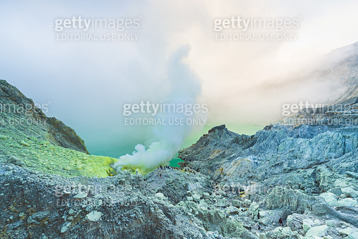 Indonesian sulfur miner is carrying sulfur from the floor of the ...