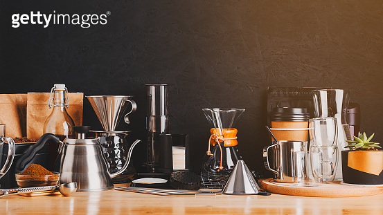 Accessories and utensils for making coffee drinks on a wooden table ...