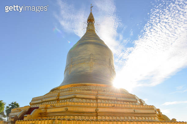 View beyond tree on bright golden Lawkananda pagoda Yangon (Rangoon ...