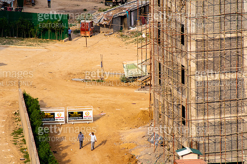 Under construction multi story building with rusted scaffolding and an ...