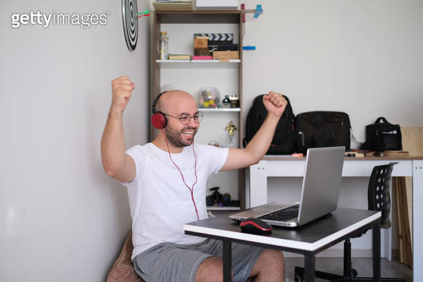Young man who succeeded at the computer. rejoicing man celebrating his ...
