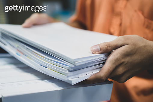 Office workers employee holding stacks of lot documents report papers ...
