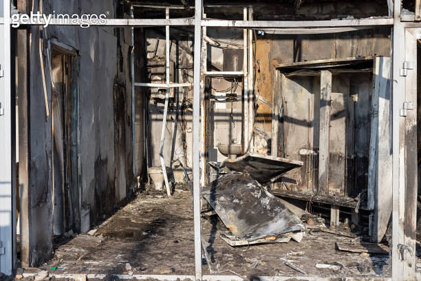 burnt room at the grocery store. Burned furniture and charred walls in ...