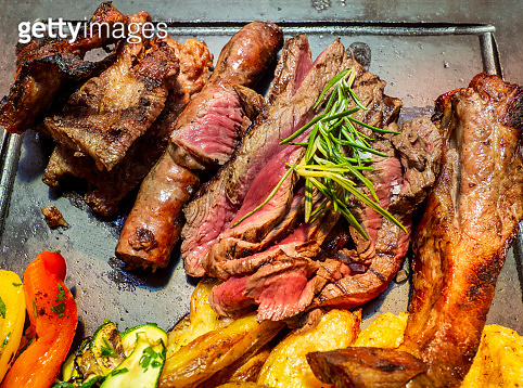 Delicious mix of grilled meat cooked on the charcoal. Meat cooked to ...
