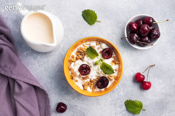 Grain curd muesli with fresh cherries on a plate. Concept healthy ...