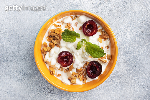 Grain curd muesli with fresh cherries on a plate. Concept healthy ...