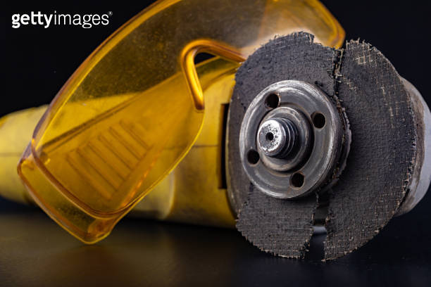 Damaged cutting disc for metal in an angle grinder. Power tools in a ...