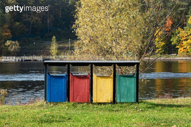 old Colorful Recycle Bins In The Park. urns for separate collection of ...
